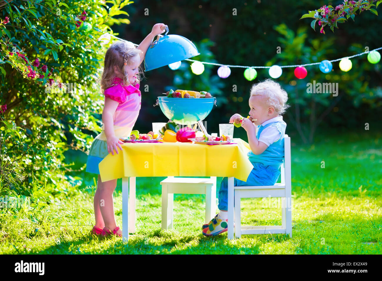 Children grilling meat. Family camping and enjoying BBQ. Brother and ...