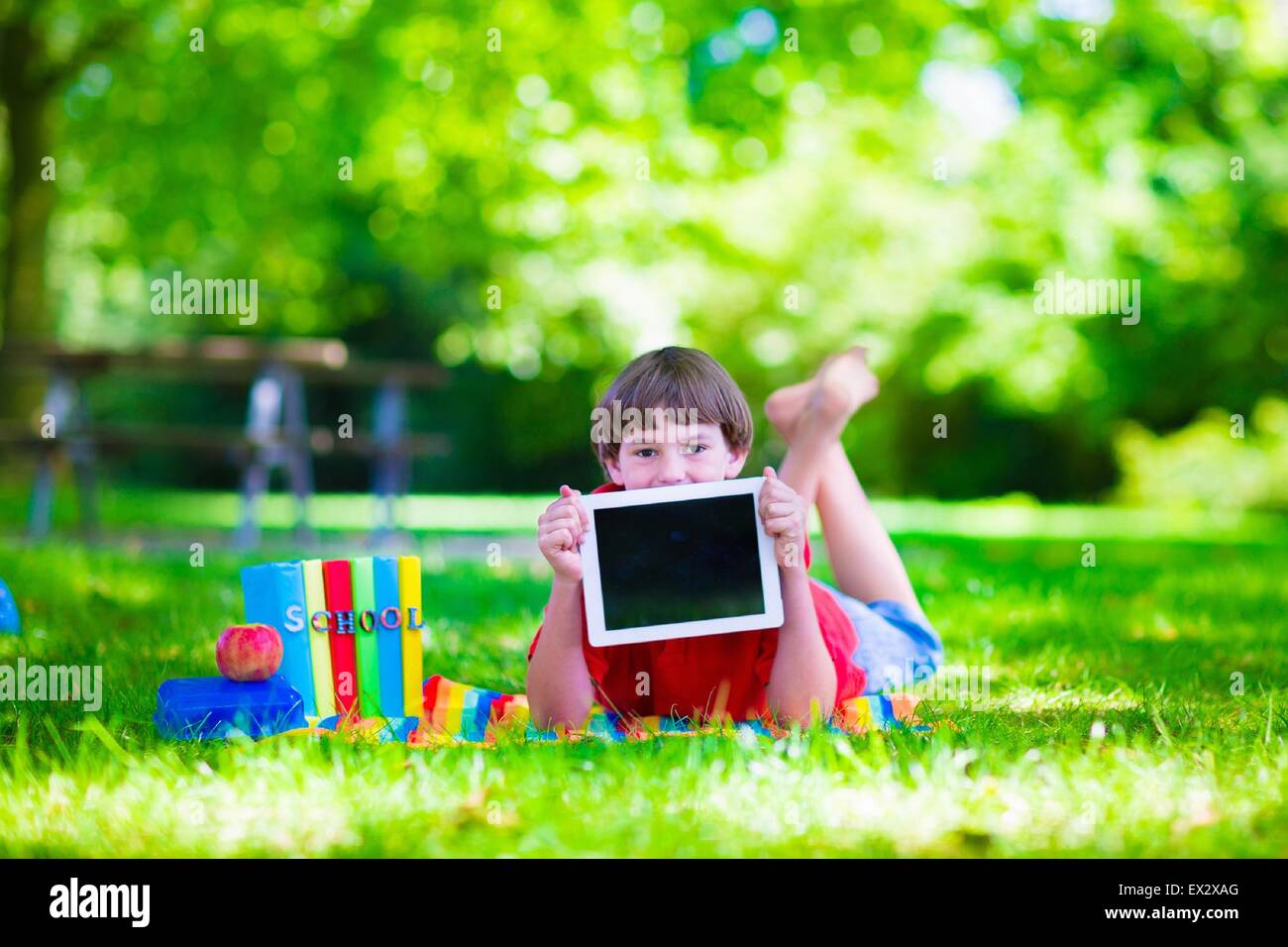 Child in school with tablet pc. Smart teenager student boy studying ...