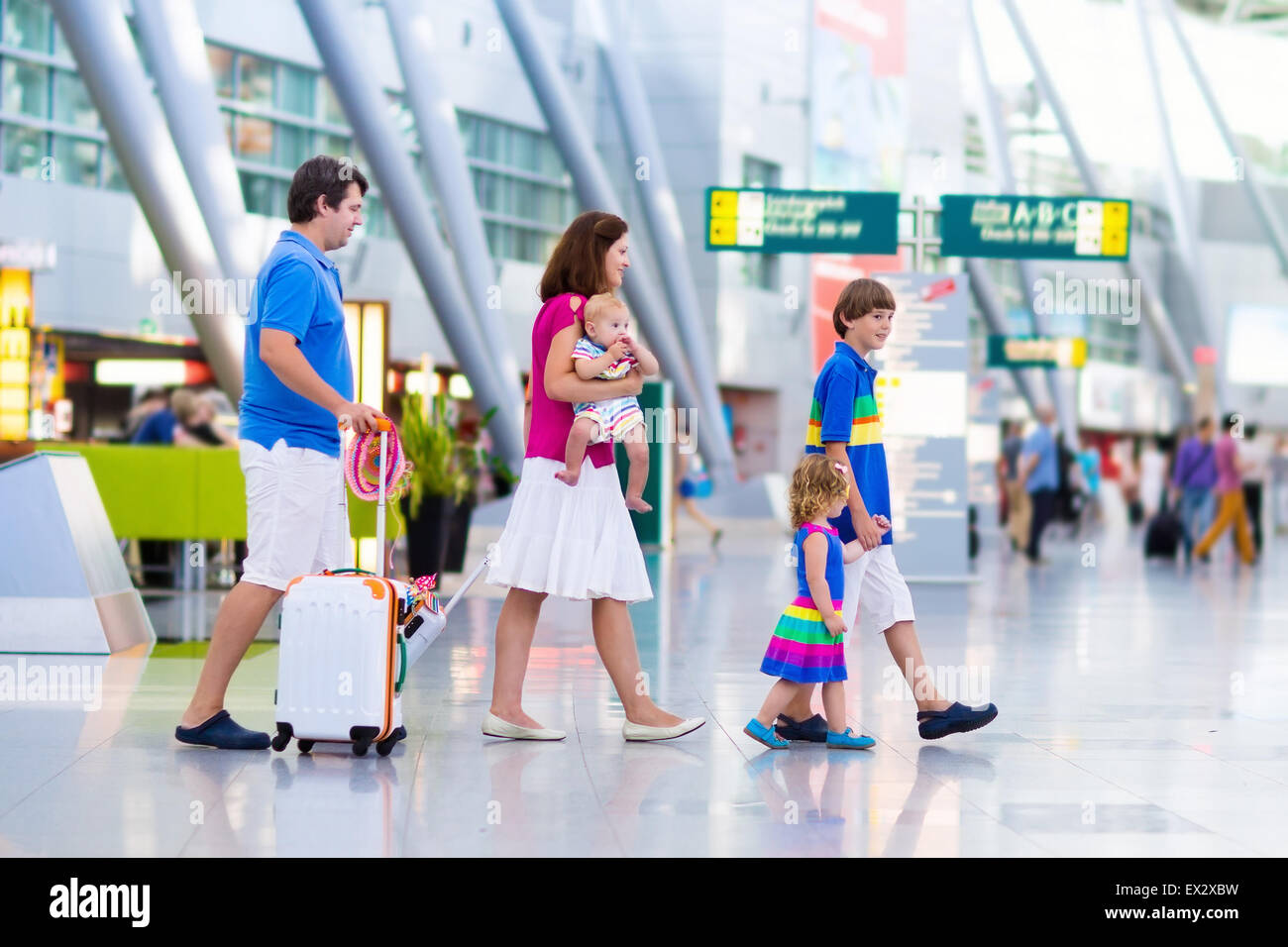 Family traveling with kids. Parents with children at international ...