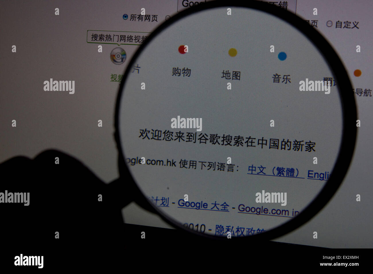 A person poses with a magnifying glass in front of a Google search page ...