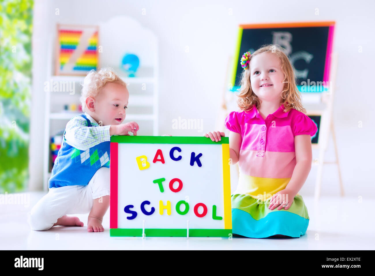 Kids at preschool. Two children drawing and painting at kindergarten ...
