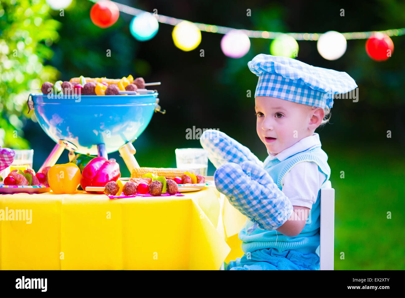 Children grilling meat. Family camping and enjoying BBQ. Little boy at ...