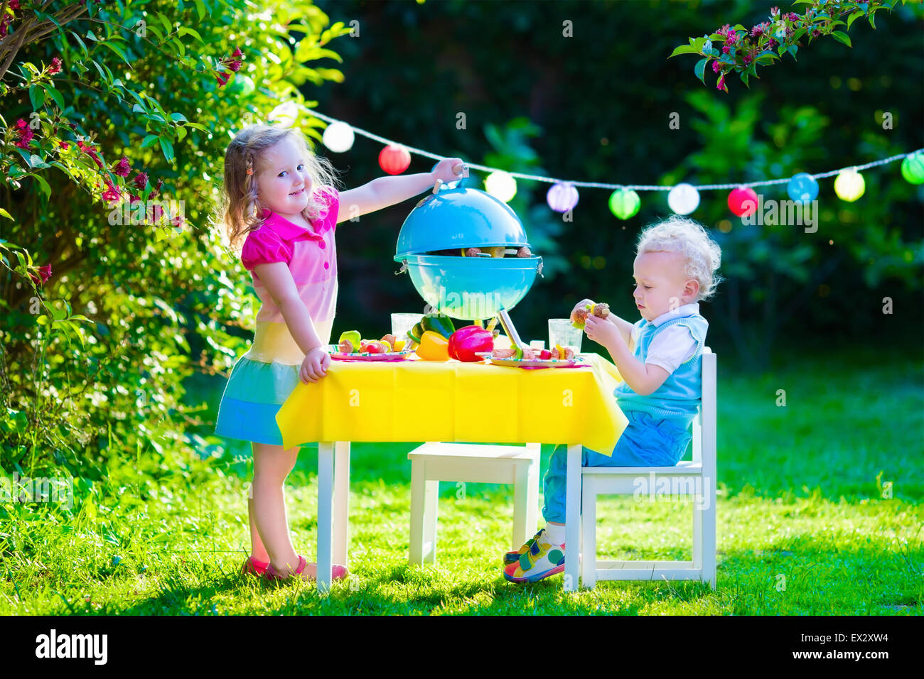 Children grilling meat. Family camping and enjoying BBQ. Brother and ...