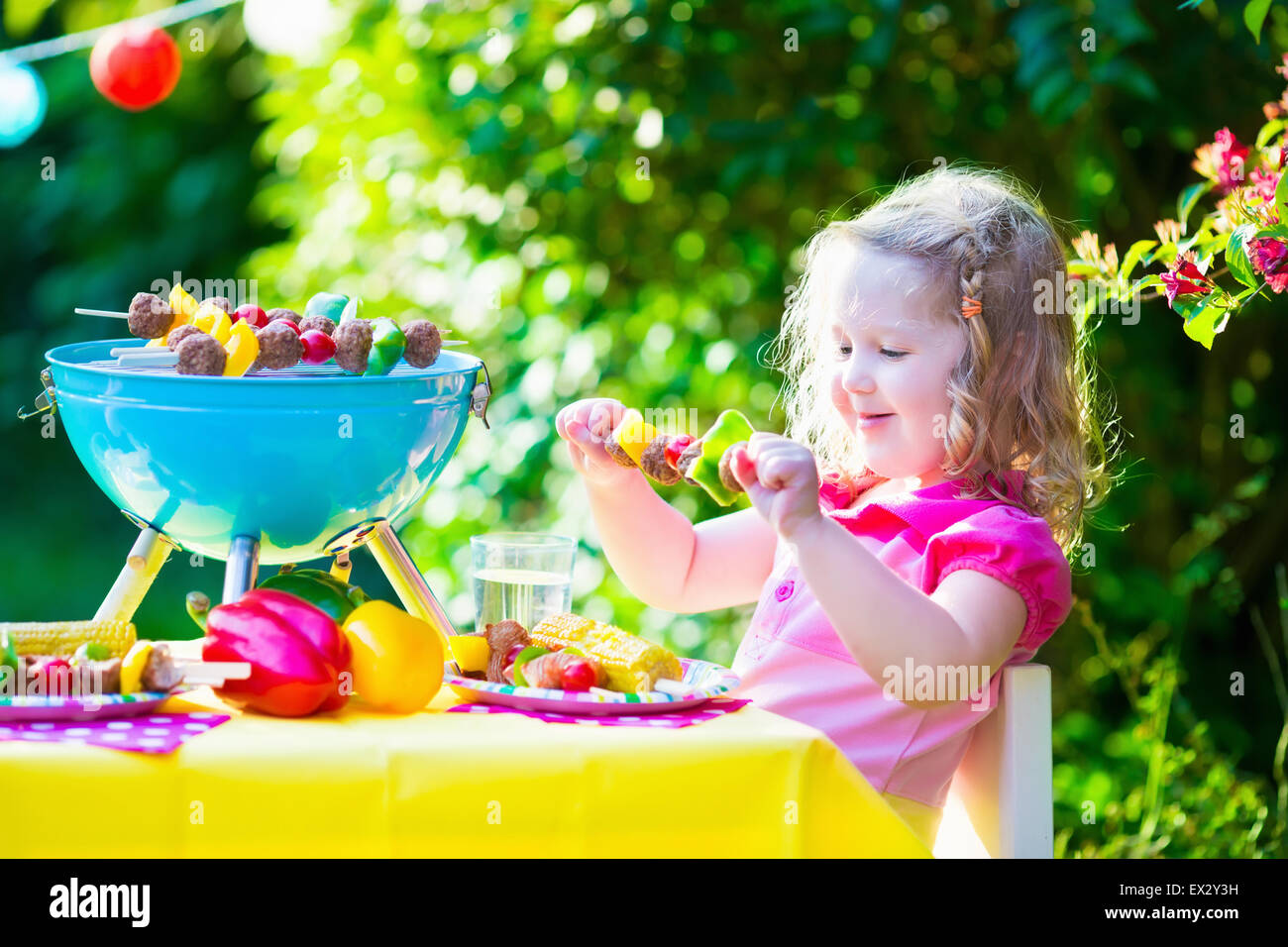 Children grilling meat. Family camping and enjoying BBQ. Little girl at ...