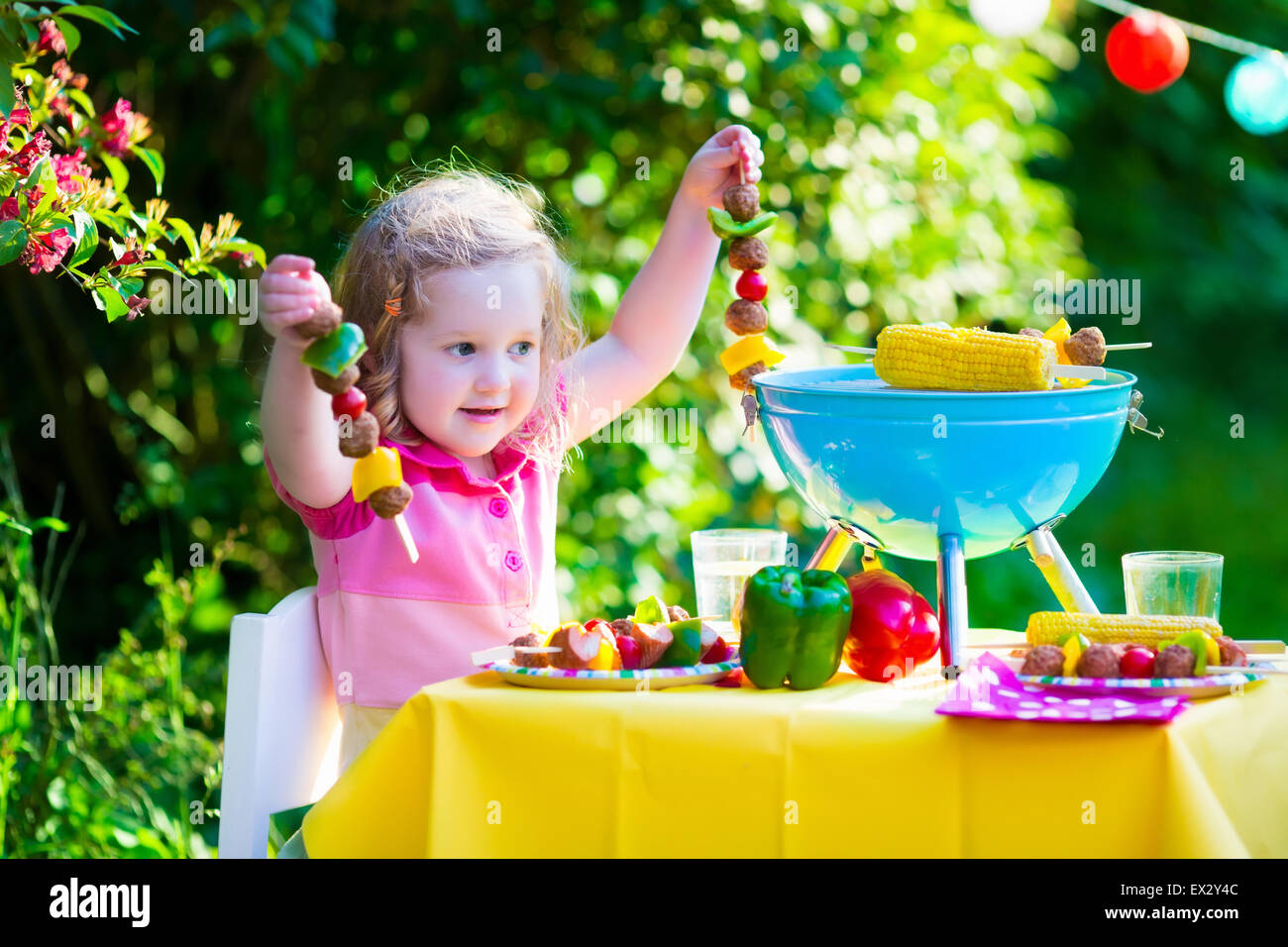 Children grilling meat. Family camping and enjoying BBQ. Little girl at ...