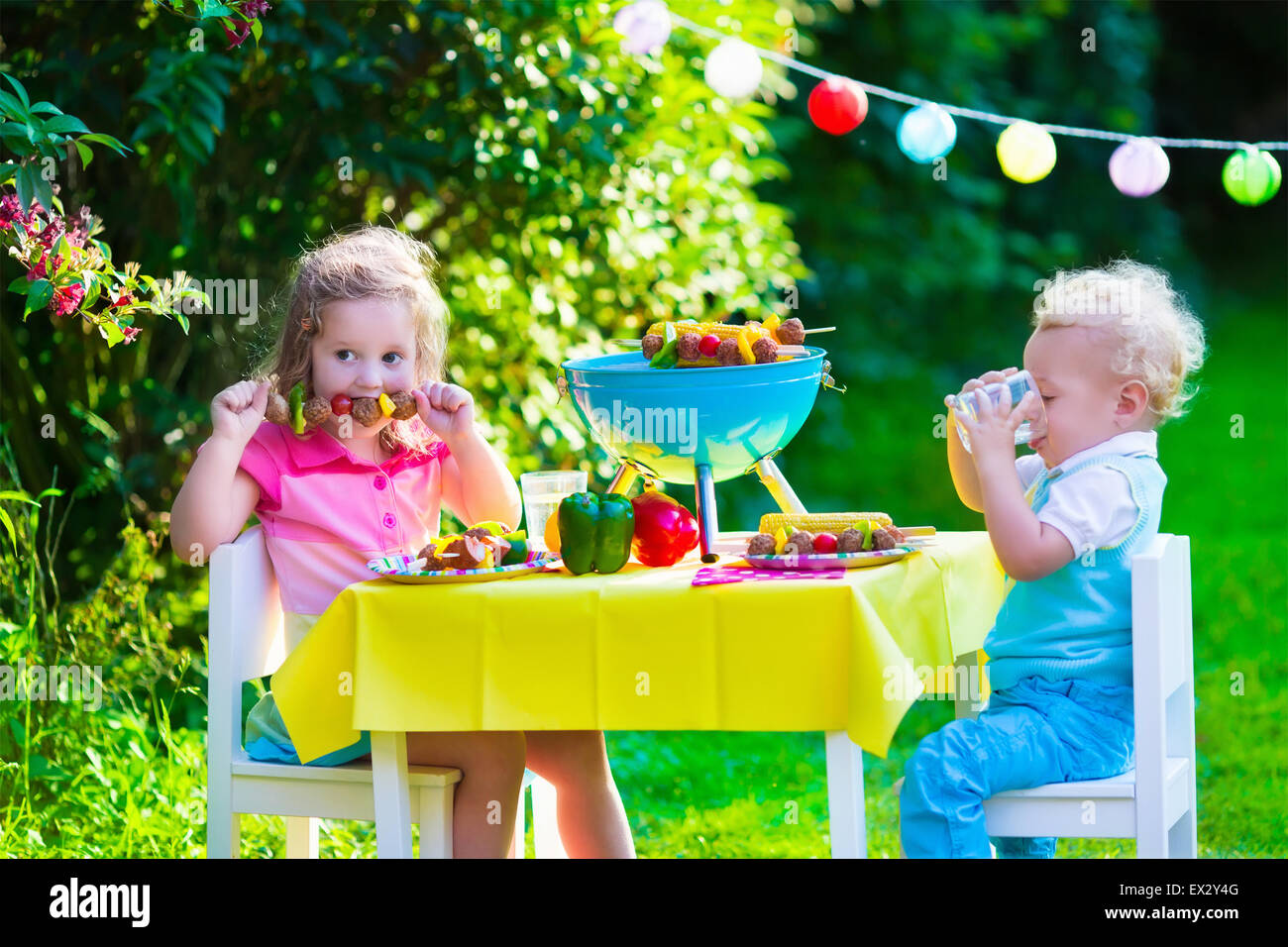 Children grilling meat. Family camping and enjoying BBQ. Brother and ...