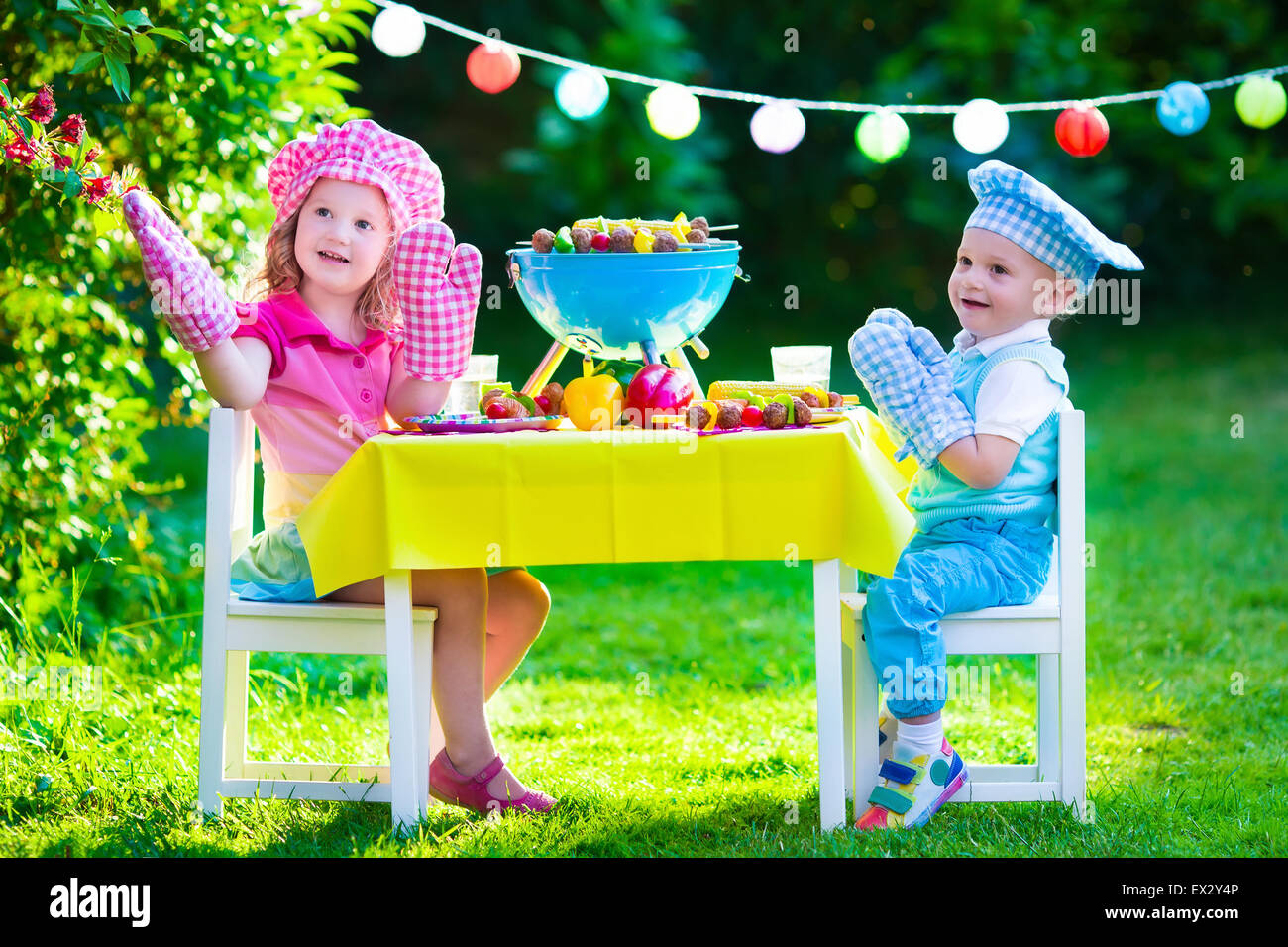 Children grilling meat. Family camping and enjoying BBQ. Brother and ...