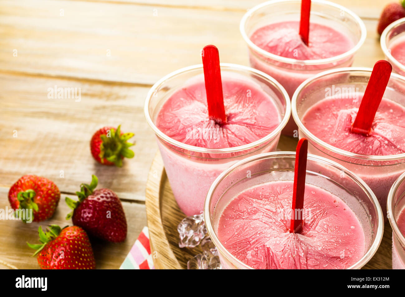 Homemade strawberry popsicles made in plastic cups Stock Photo - Alamy