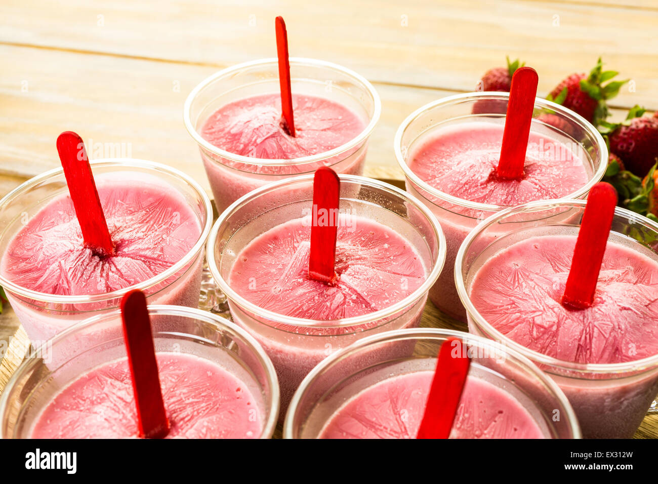 Homemade strawberry popsicles made in plastic cups Stock Photo - Alamy