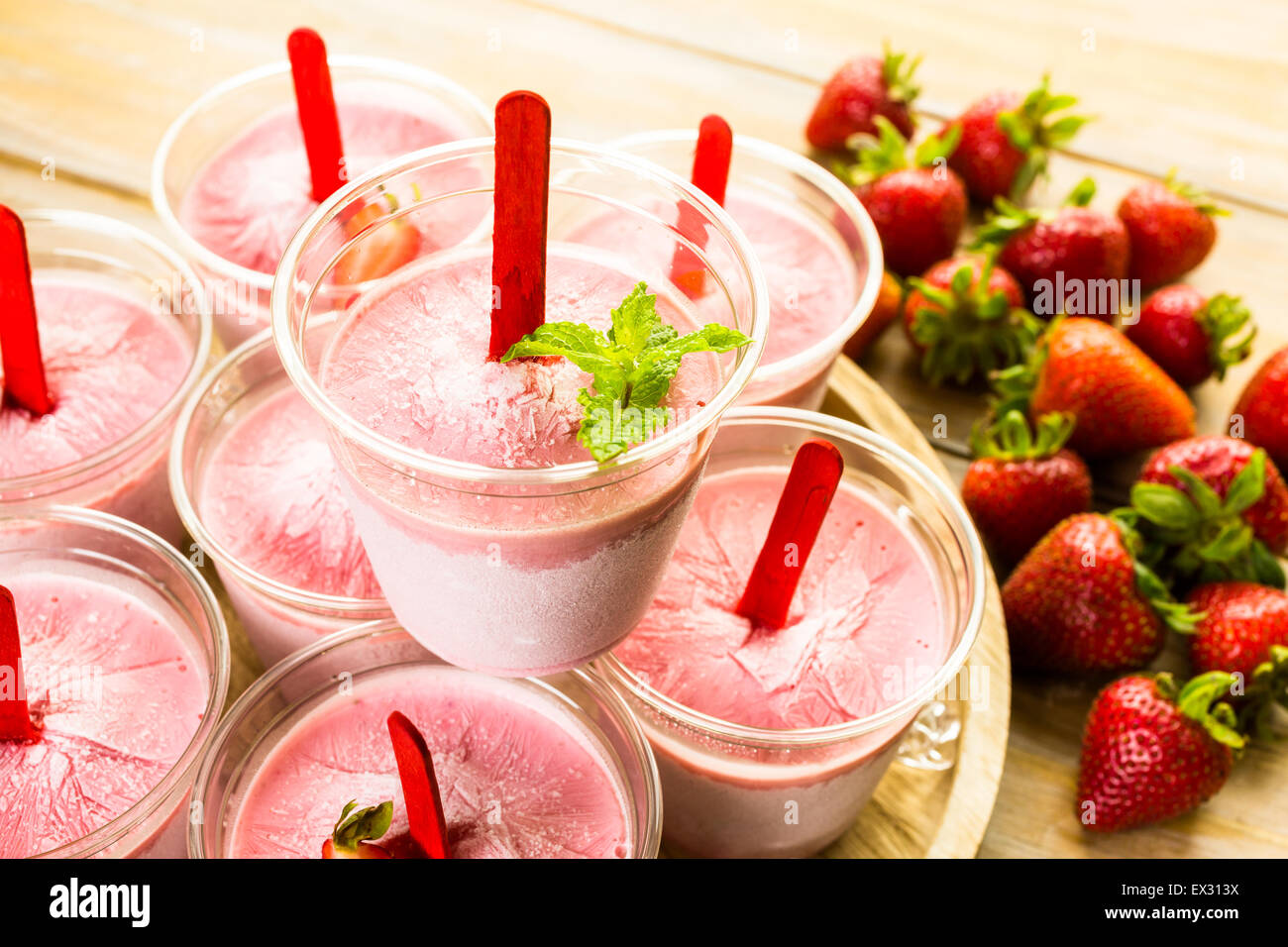 Homemade strawberry popsicles made in plastic cups Stock Photo - Alamy