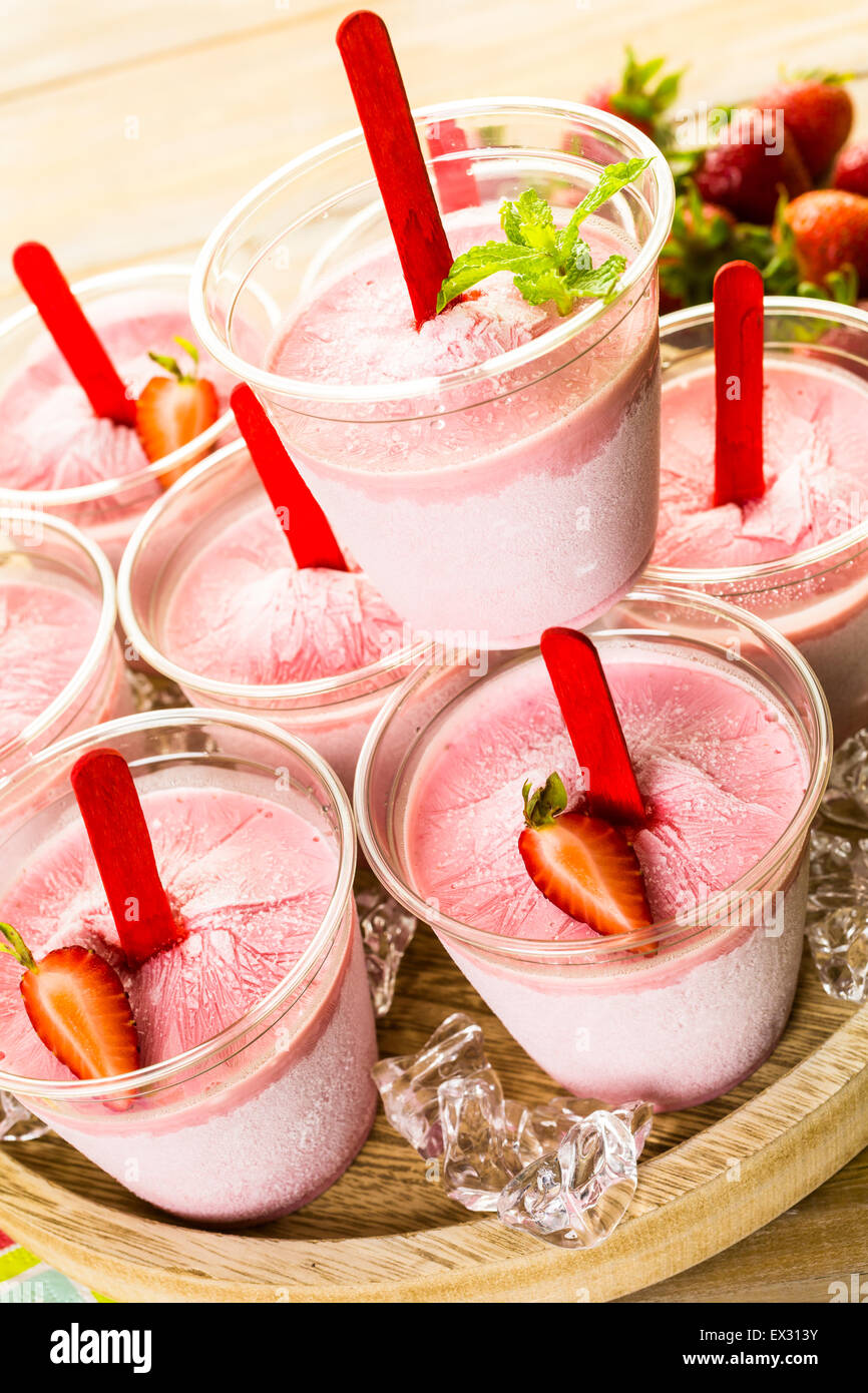 Homemade strawberry popsicles made in plastic cups Stock Photo - Alamy