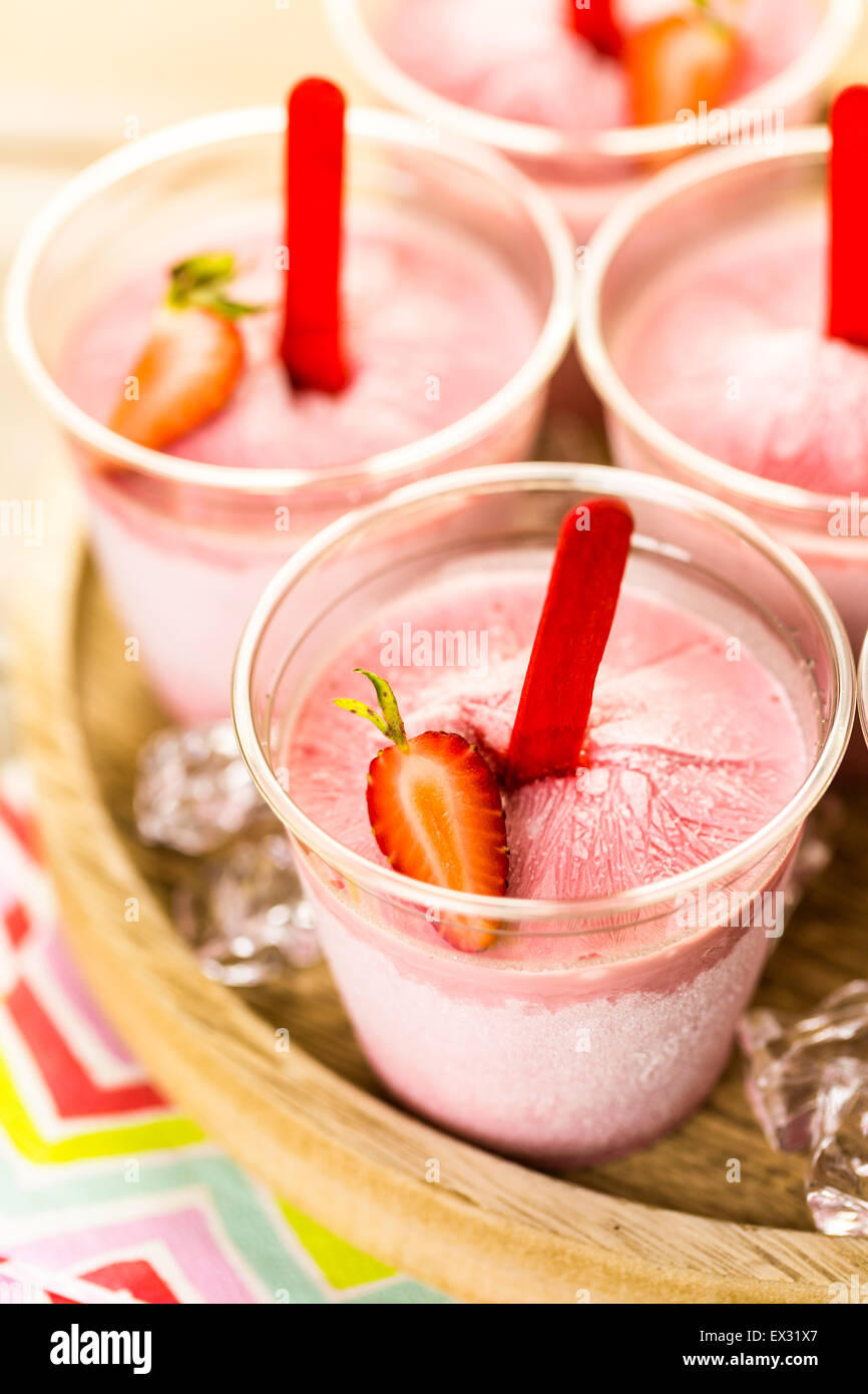 Homemade strawberry popsicles made in plastic cups Stock Photo - Alamy