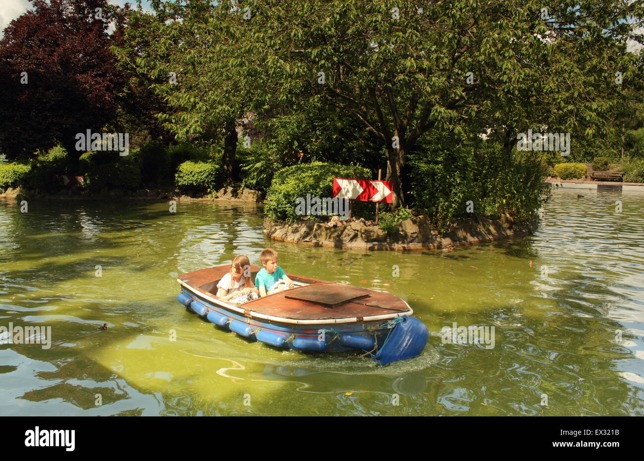 Children steer motorised boats on a pond in Hall Leys park in Matlock ...