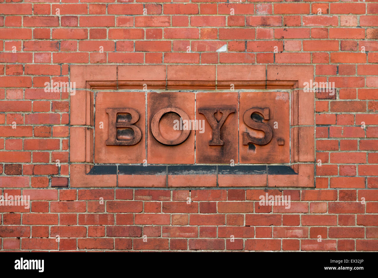 Boys sign written in brick on the side of a school building Stock Photo ...