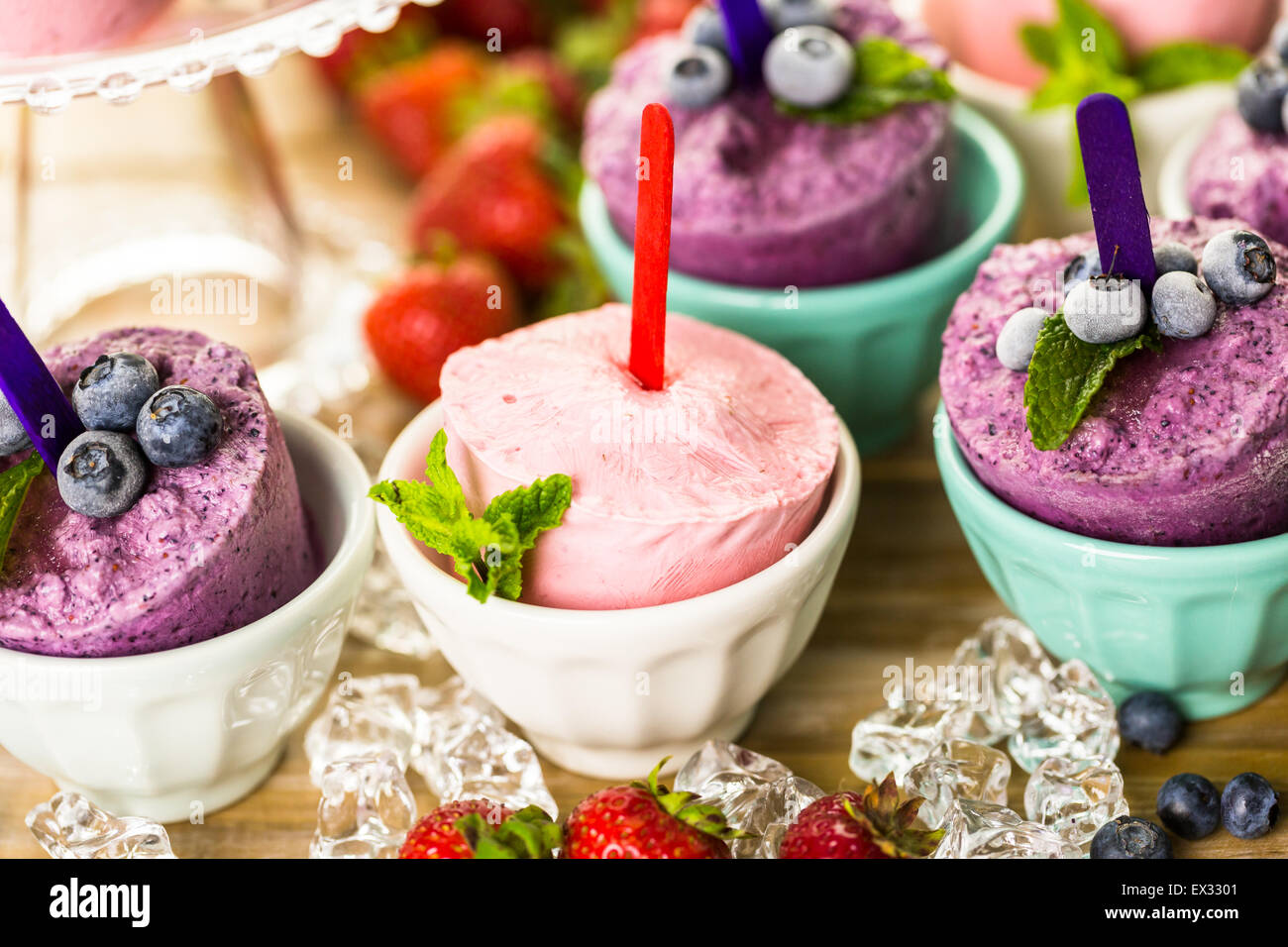 Homemade blueberry and strawberry popsicles made in plastic cups Stock ...