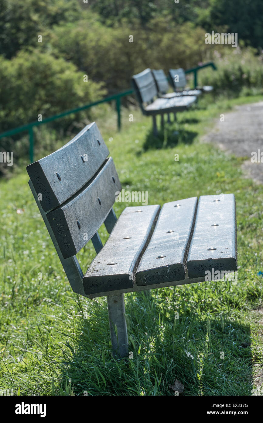 set of three benches at paths edge in park setting Stock Photo - Alamy