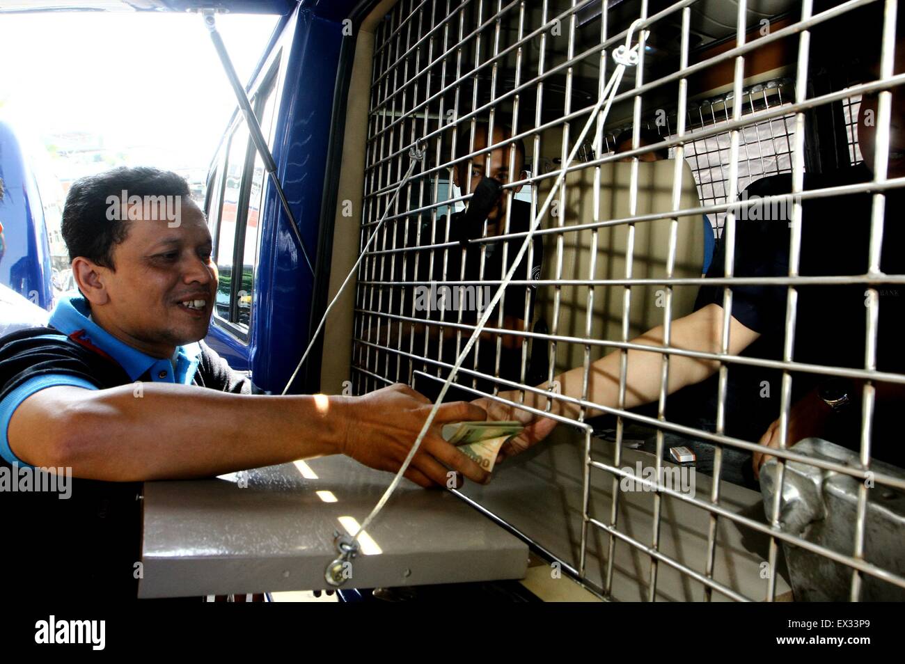 Palembang, Indonesia. 05th July, 2015. A man exchanges money in Cash ...