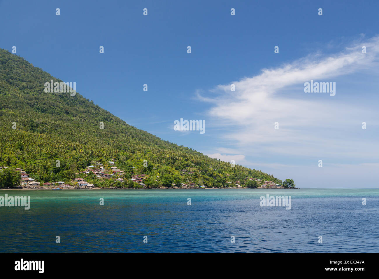 A small beach village nestled on at the base of the Manado Tua volcano ...