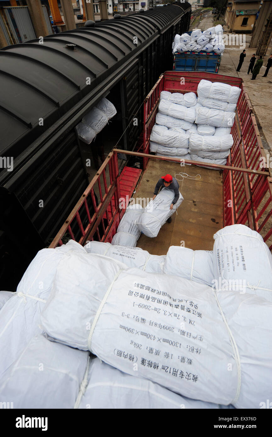 Tents are loaded on a train before aheading for the earthquake-hit ...