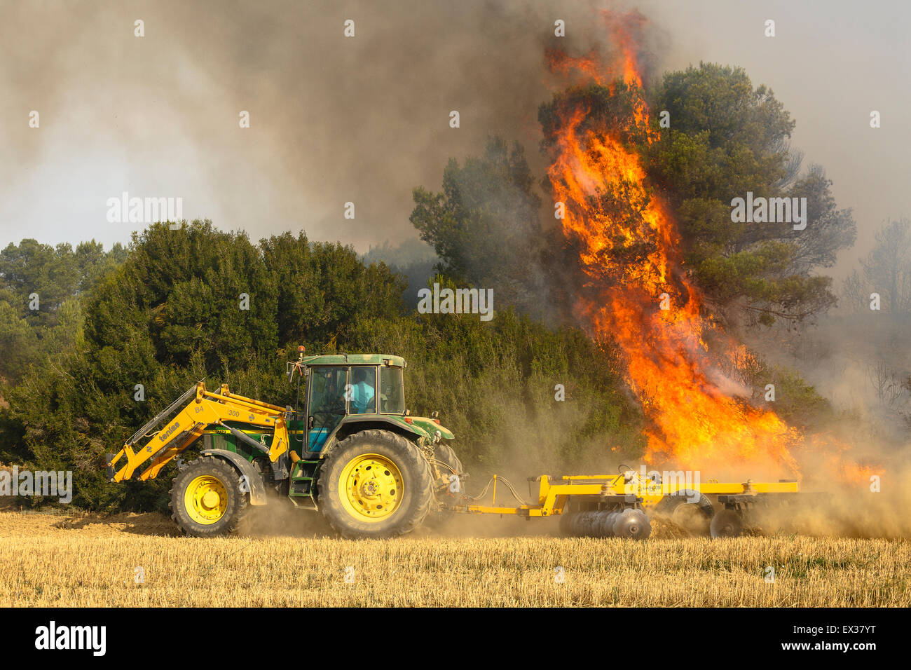 Tractor making firewall.Fire in Sierra de Luna. Cinco Villas region ...