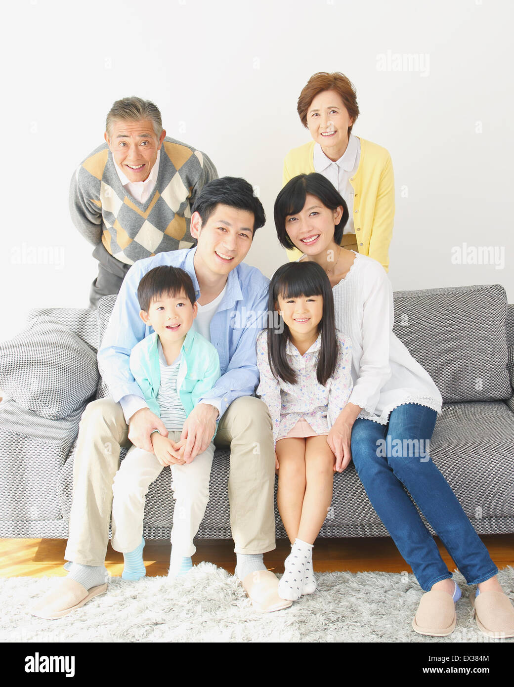 Three-generation Japanese family on the sofa in the living room Stock ...