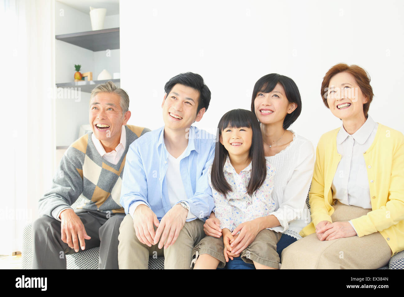 Three-generation Japanese family on the sofa in the living room Stock ...