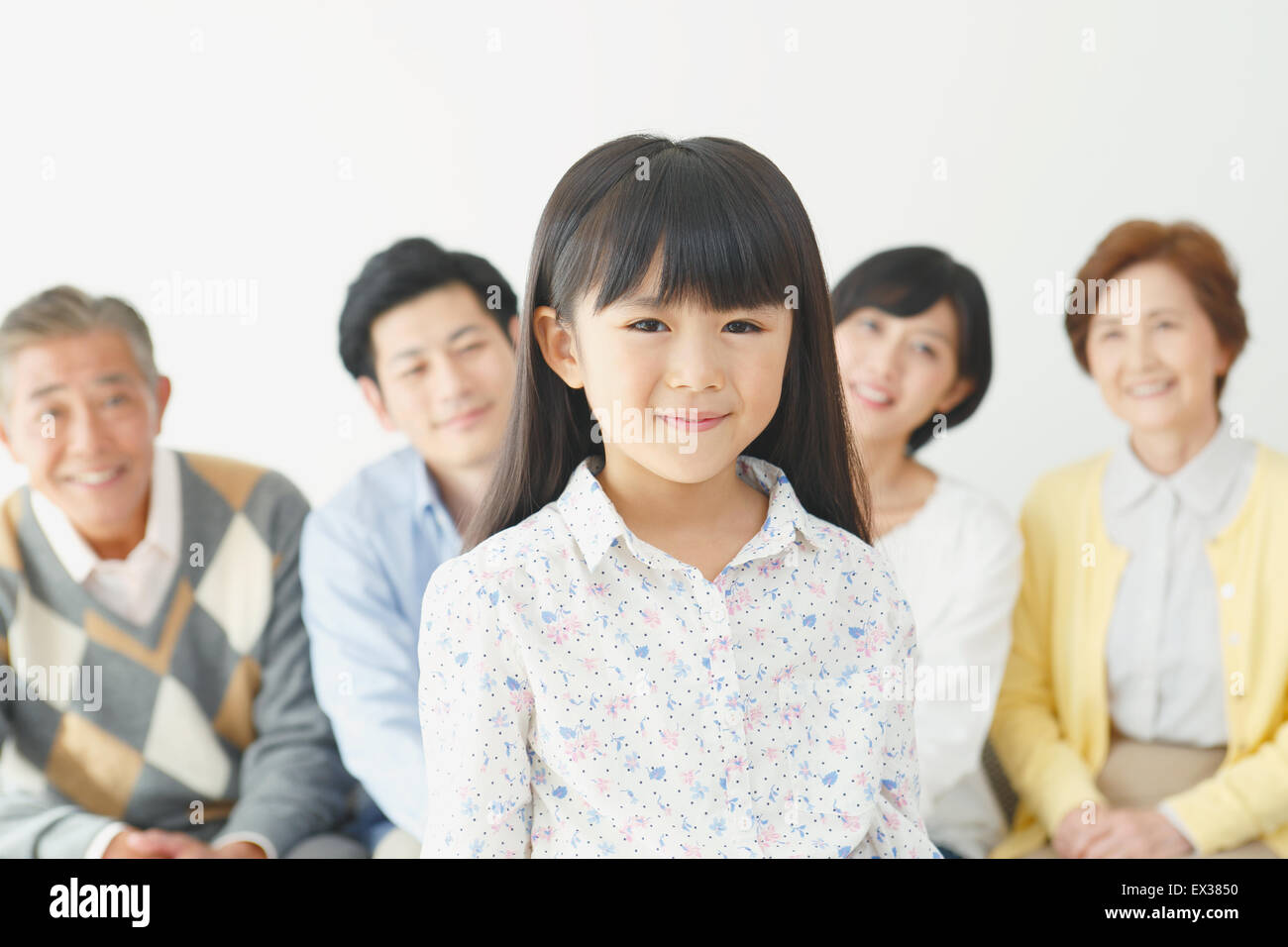 Three-generation Japanese family on the sofa in the living room Stock ...