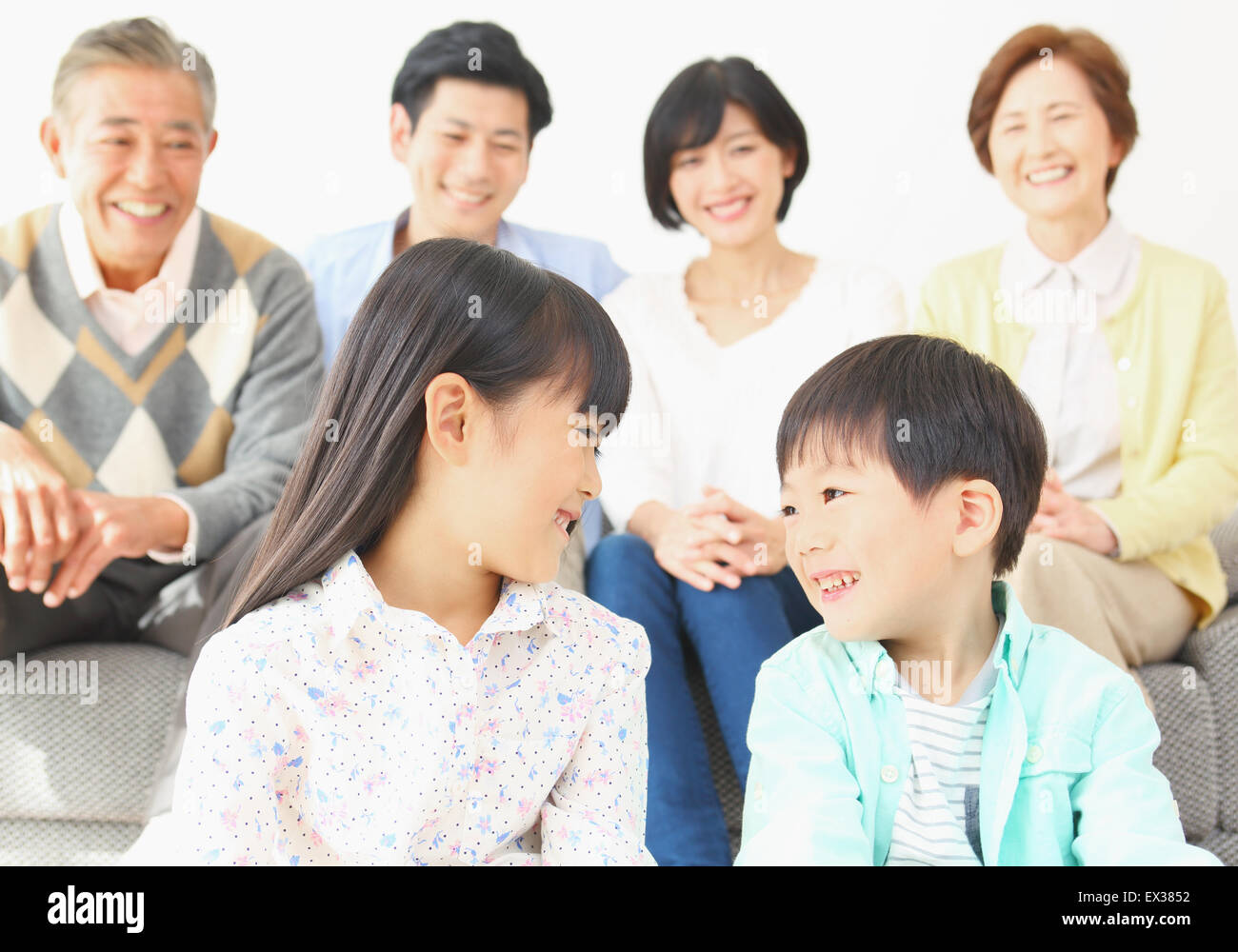 Three-generation Japanese family on the sofa in the living room Stock ...
