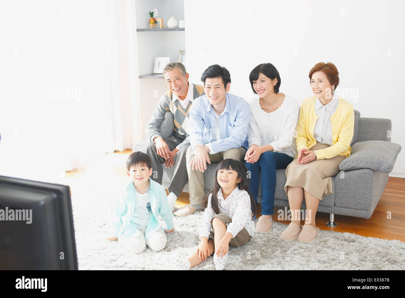 Three-generation Japanese family on the sofa in the living room Stock ...