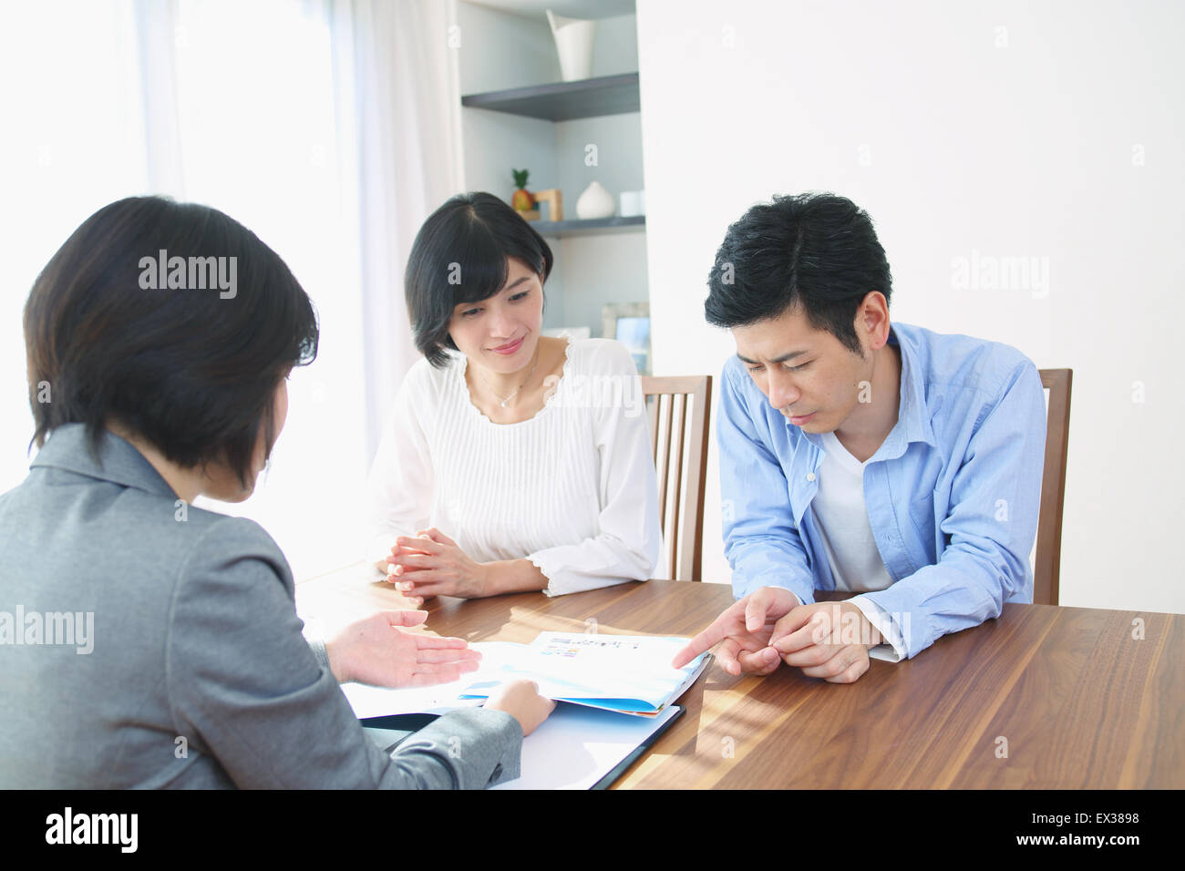 Young Japanese couple consulting with financial planner Stock Photo - Alamy