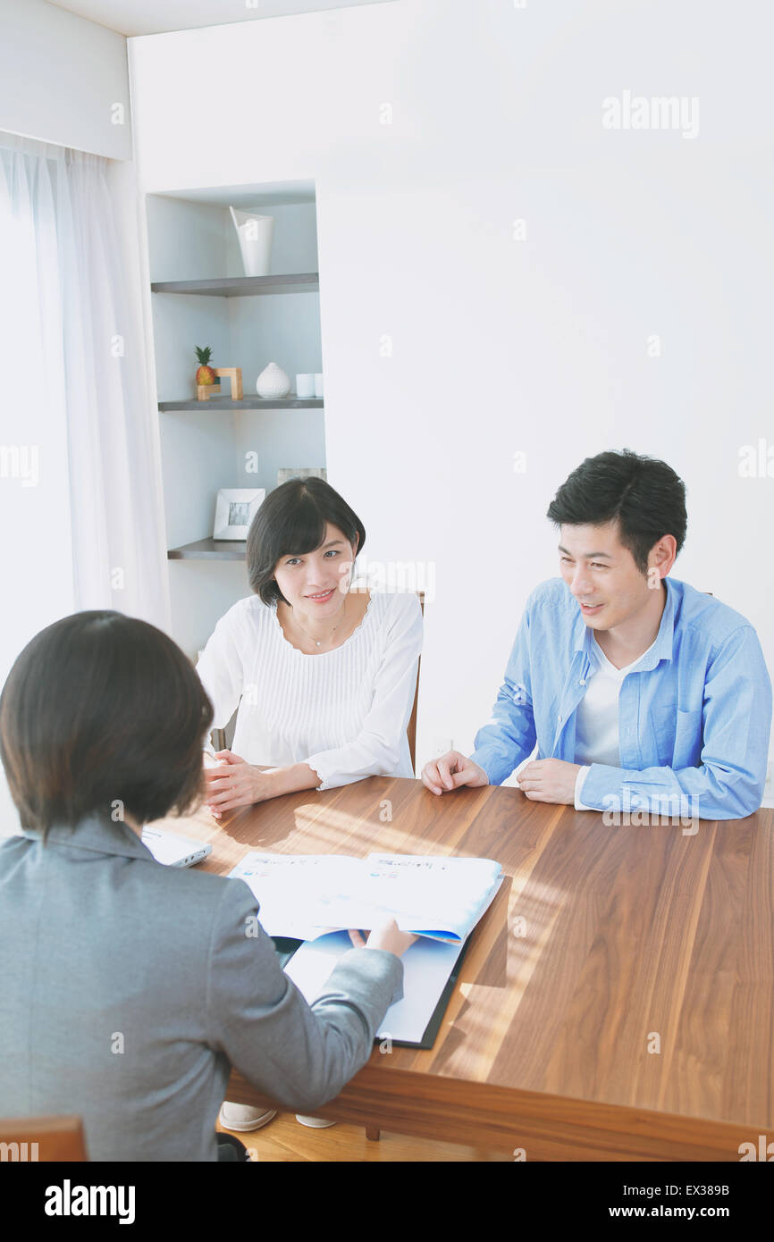 Young Japanese couple consulting with financial planner Stock Photo - Alamy