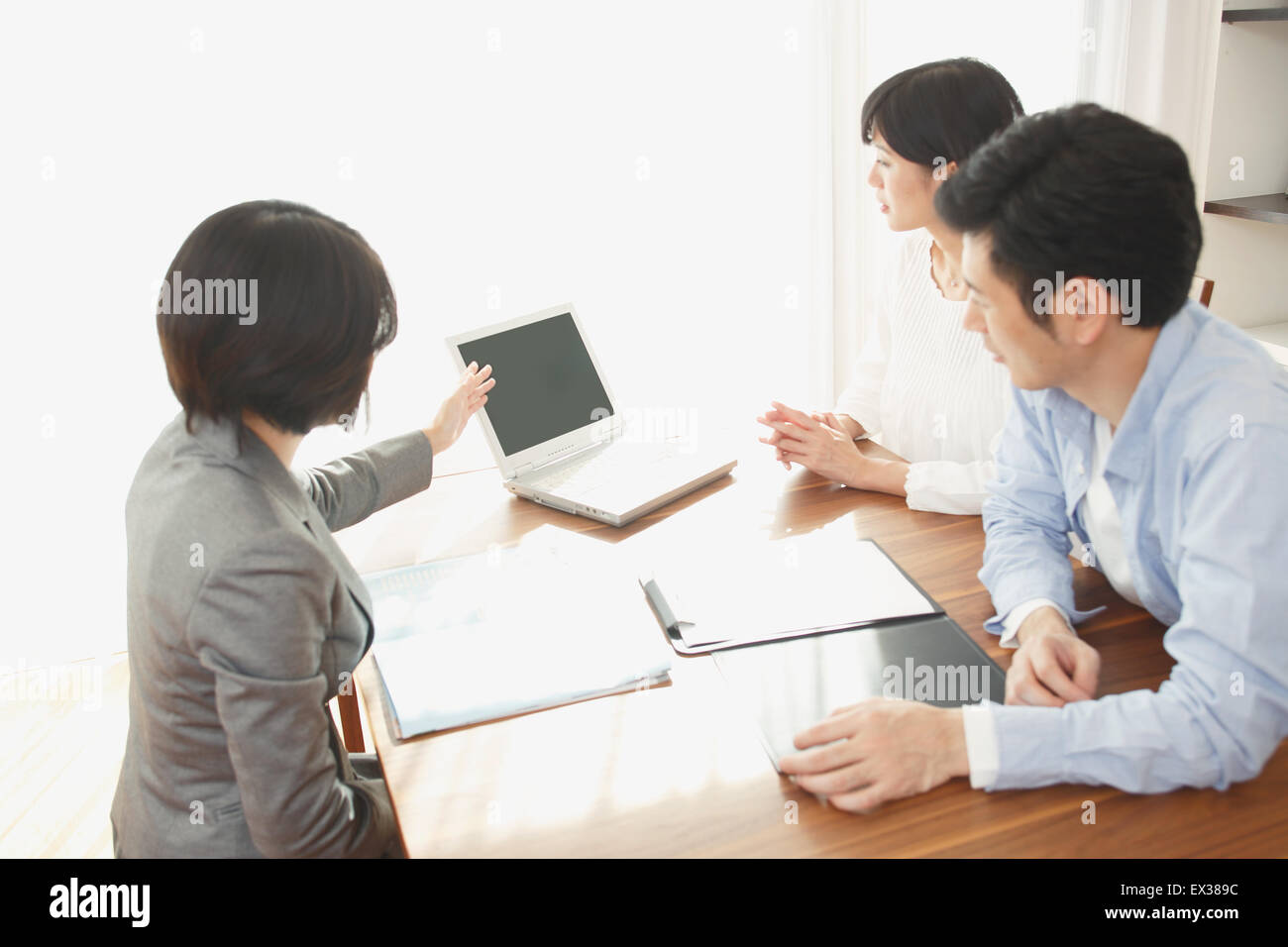 Young Japanese couple consulting with financial planner Stock Photo - Alamy
