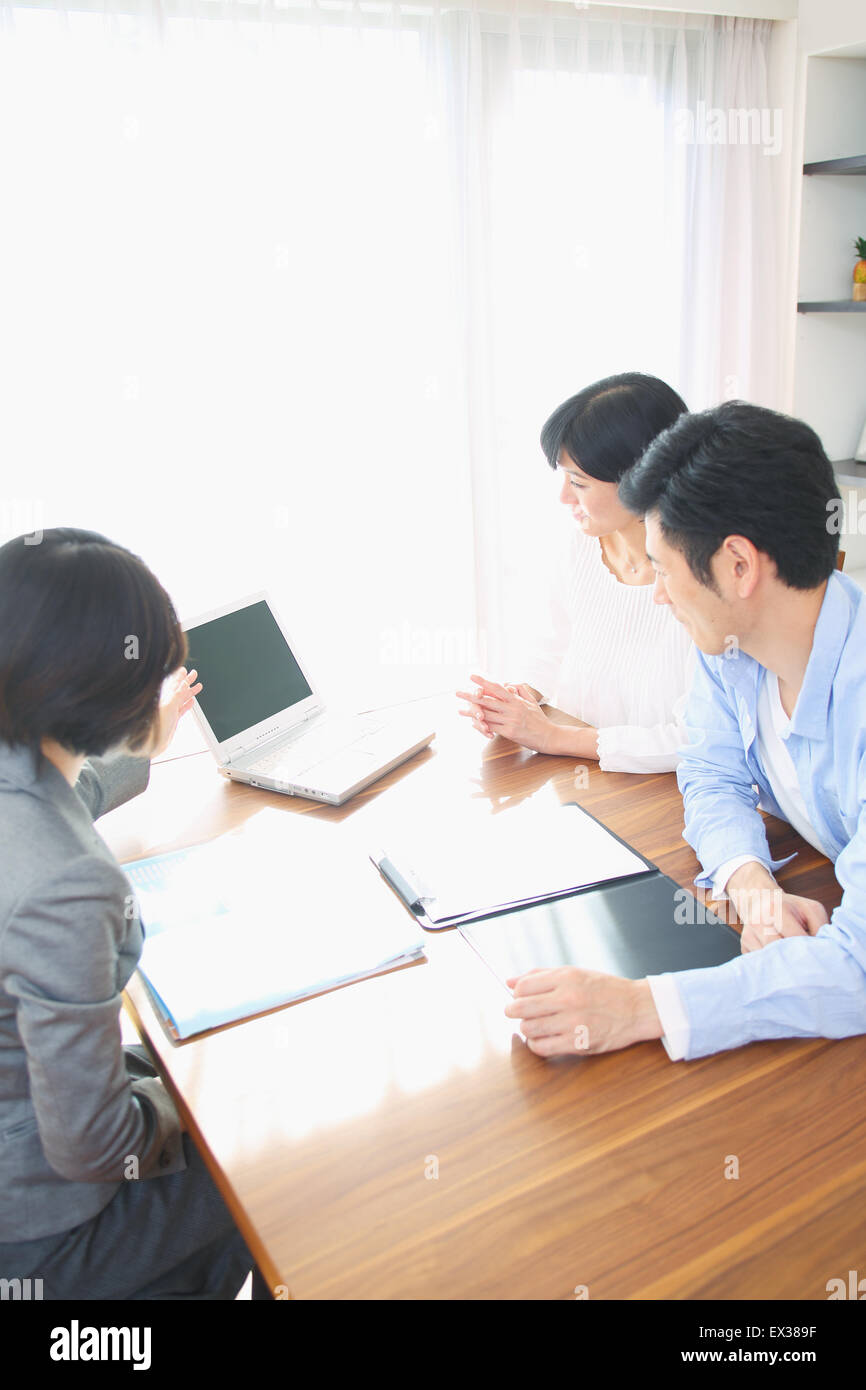 Young Japanese couple consulting with financial planner Stock Photo - Alamy