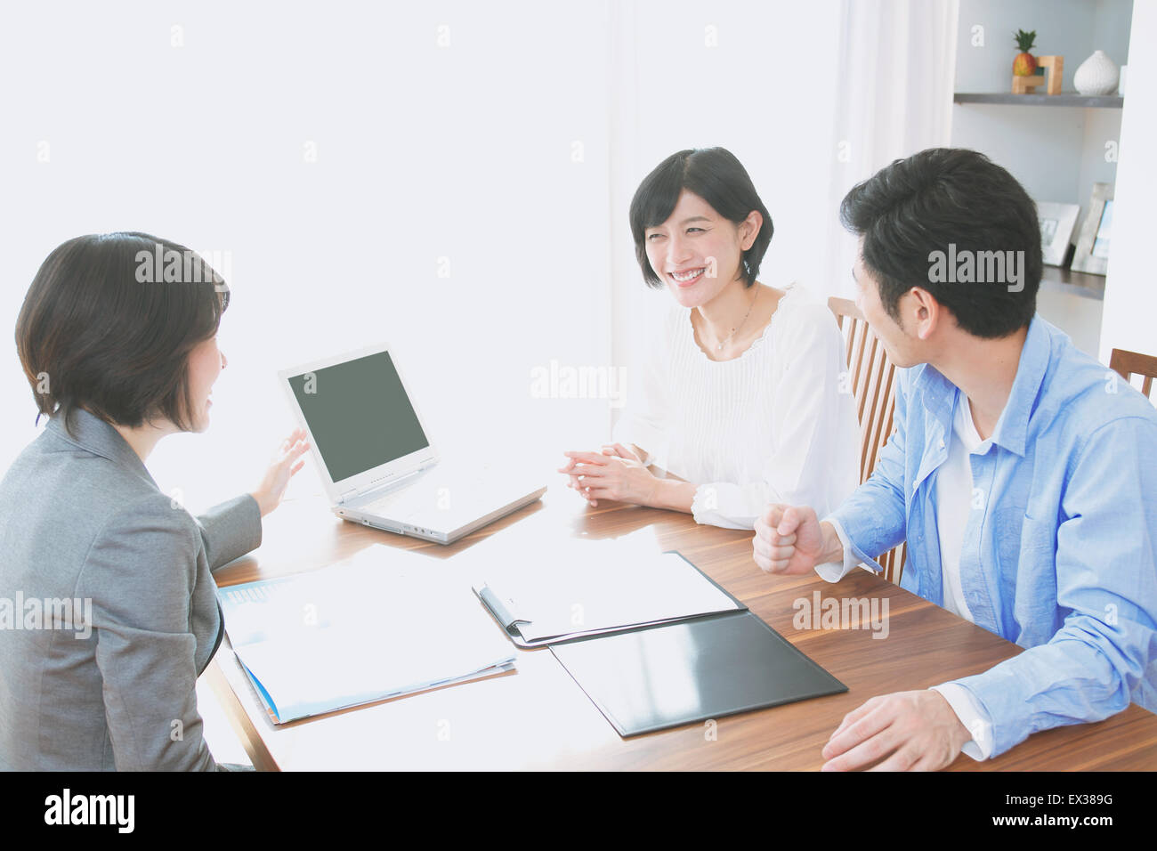 Young Japanese couple consulting with financial planner Stock Photo - Alamy