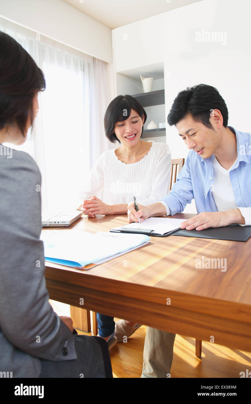Young Japanese couple consulting with financial planner Stock Photo - Alamy