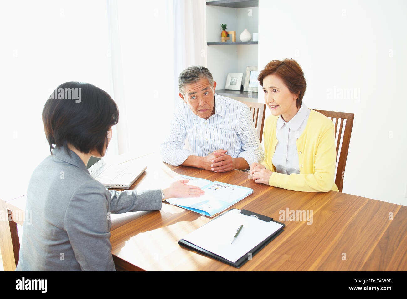 Senior Japanese couple consulting with financial planner Stock Photo ...