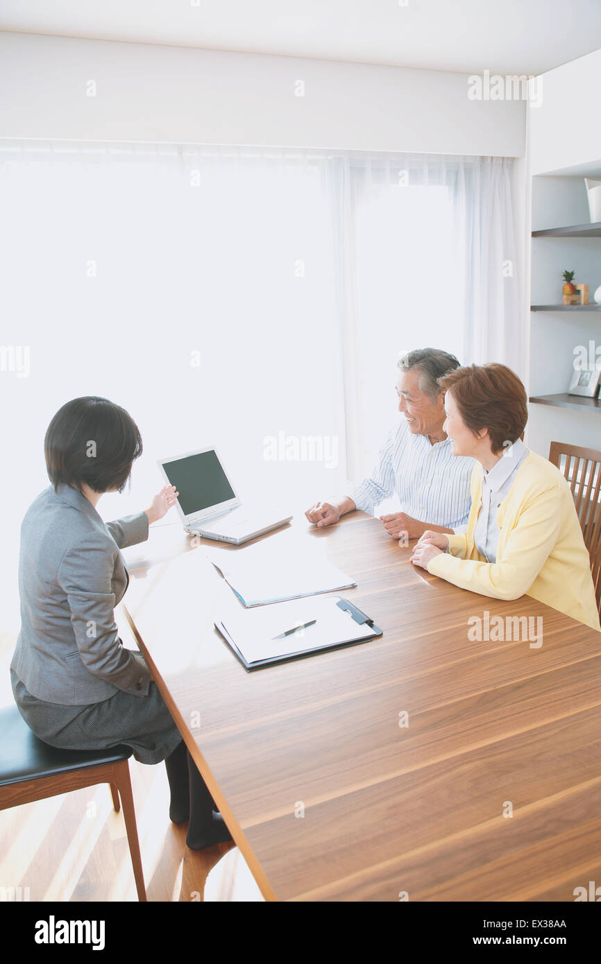Senior Japanese couple consulting with financial planner Stock Photo ...