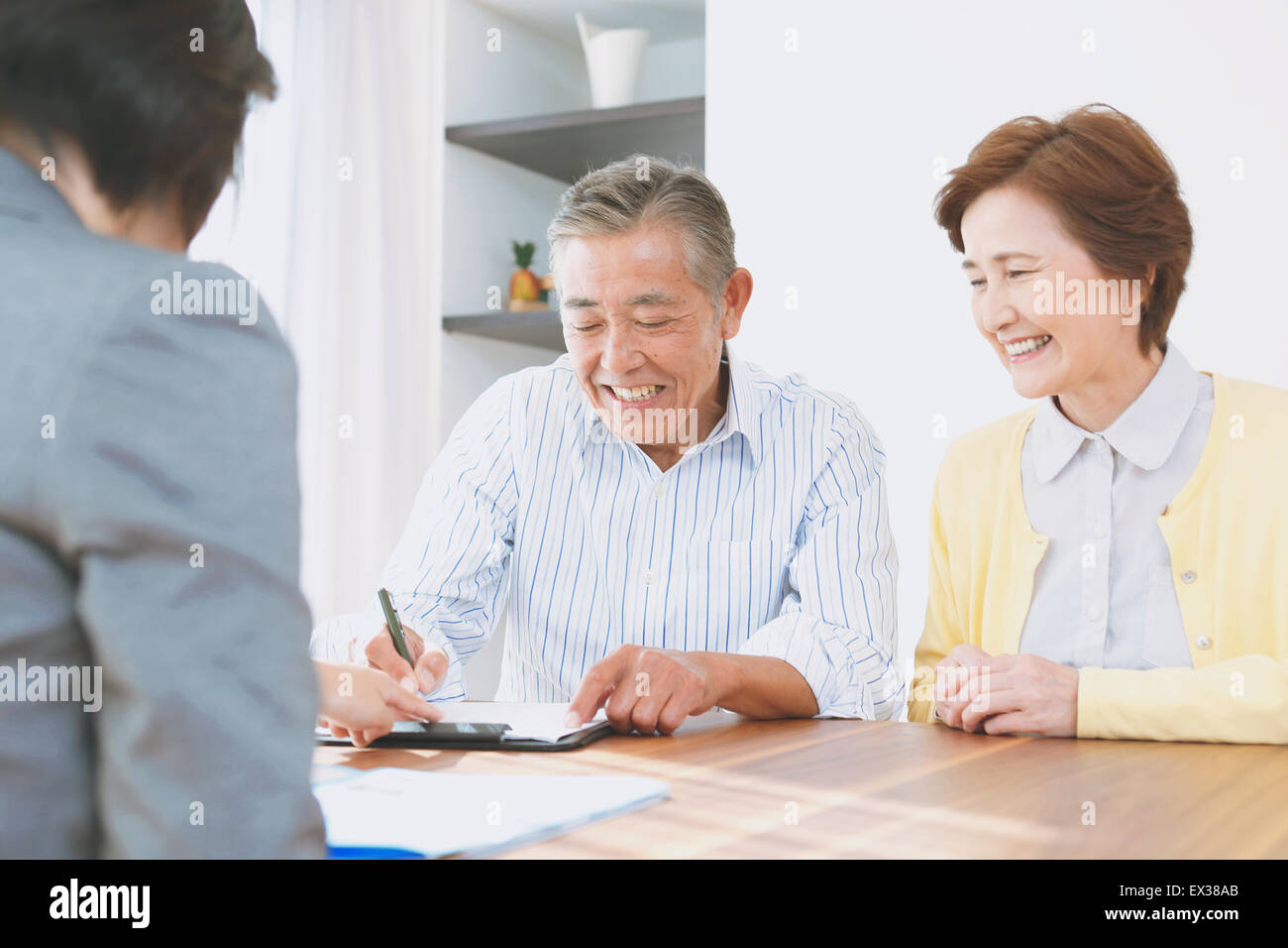 Senior Japanese couple consulting with financial planner Stock Photo ...
