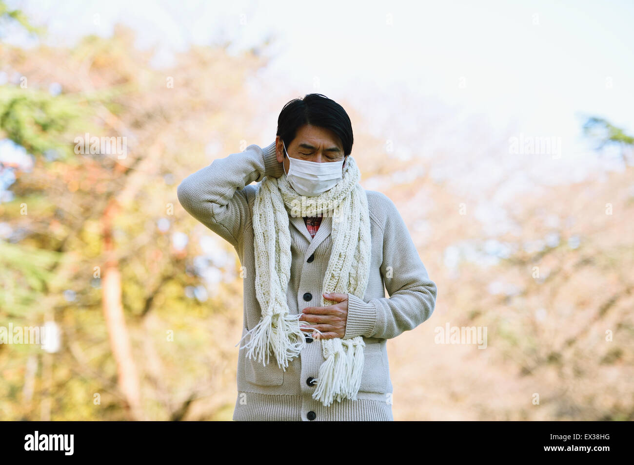 Senior Japanese man with mask feeling sick Stock Photo - Alamy