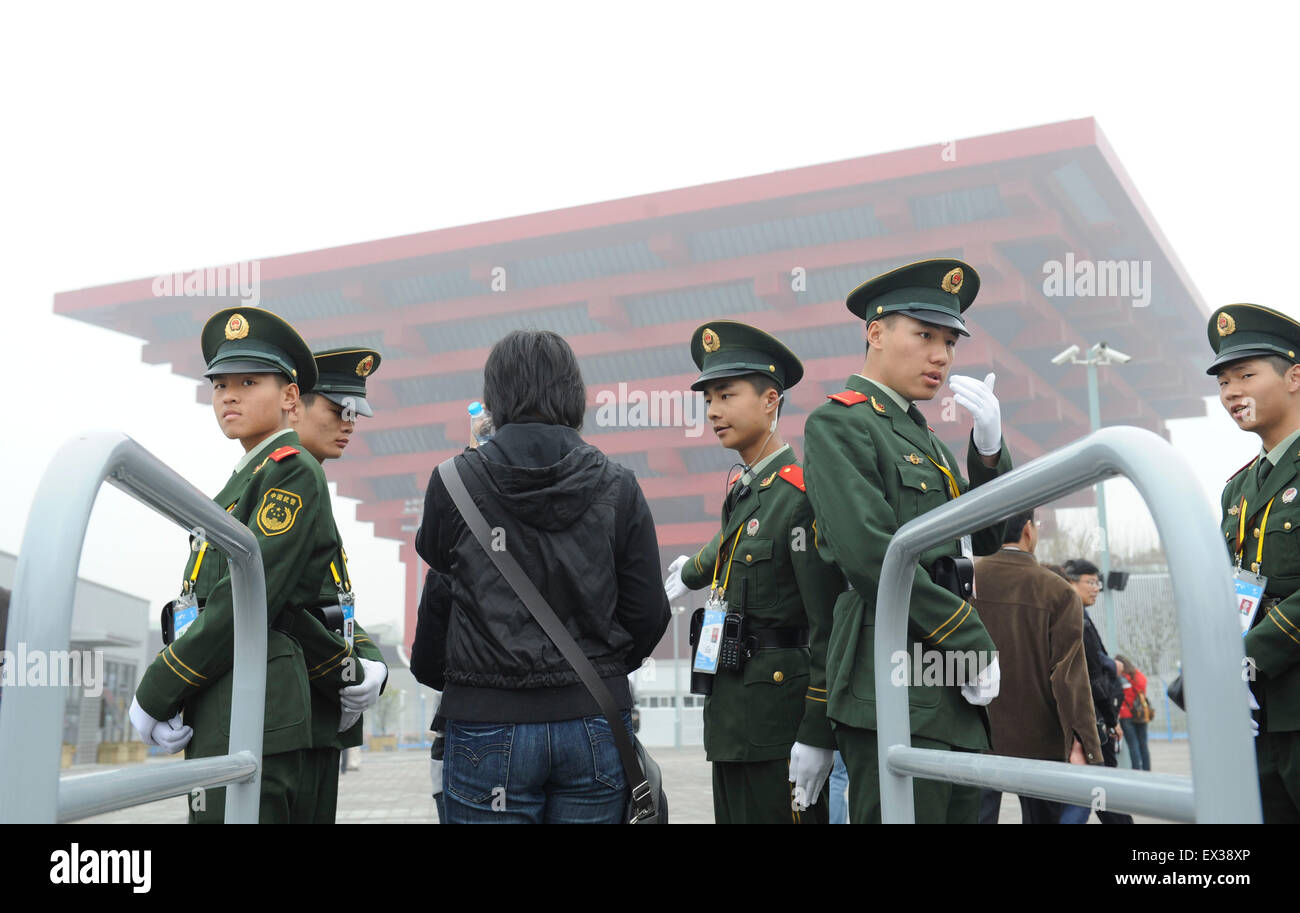 Paramilitary policemen stand guard at an entrance of the Shanghai World ...