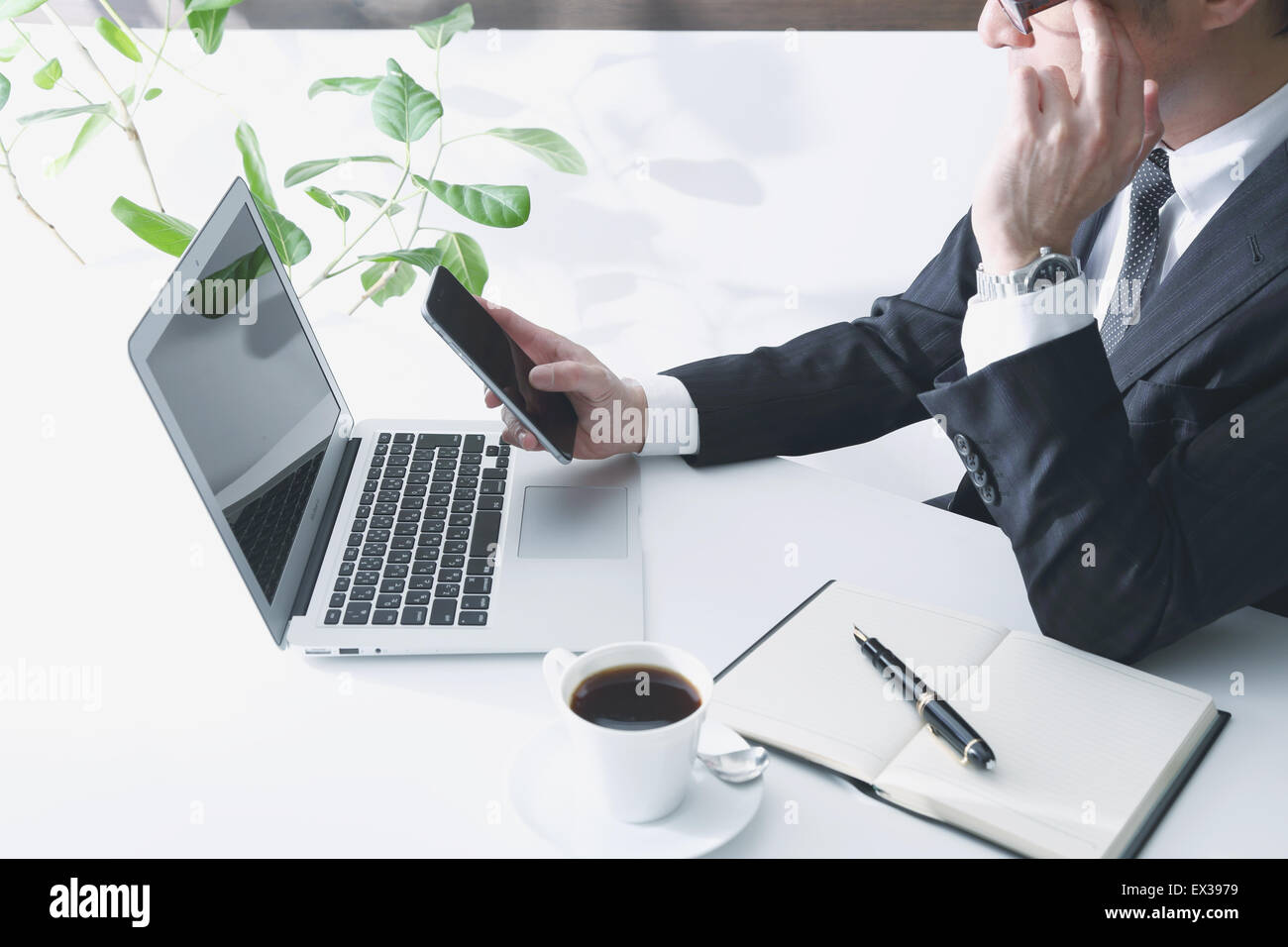 Japanese businessman working with large display smartphone Stock Photo ...