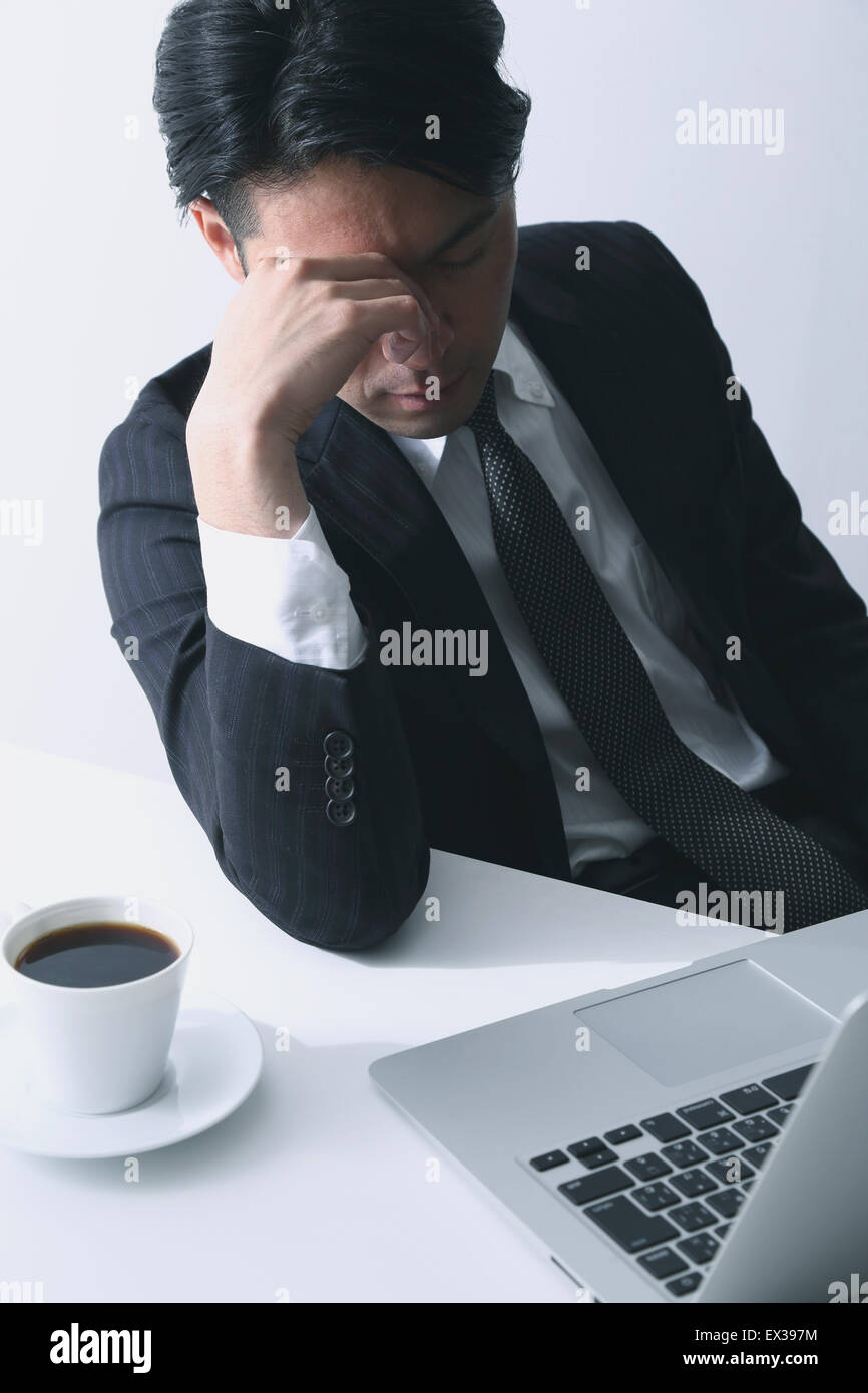 Tired Japanese businessman Stock Photo - Alamy