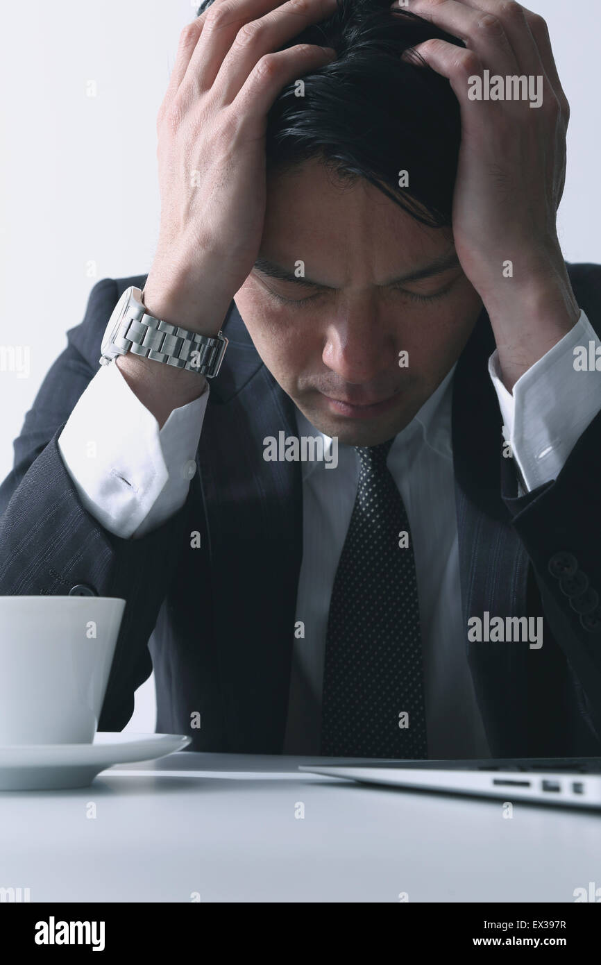 Tired Japanese businessman Stock Photo - Alamy