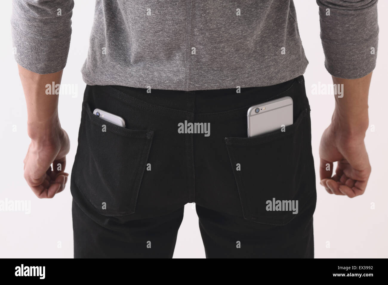 Young man with smartphones in his pockets Stock Photo - Alamy