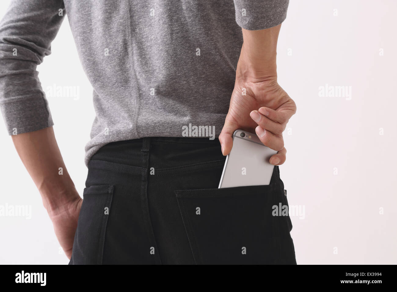 Young man with smartphone in his pocket Stock Photo - Alamy
