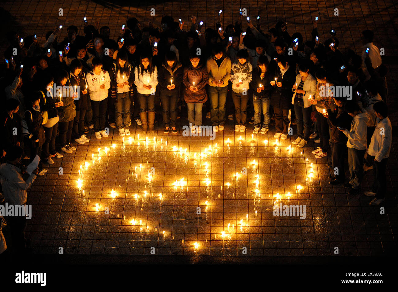 People mourn for victims of the April 14 Yushu Earthquake at a square ...
