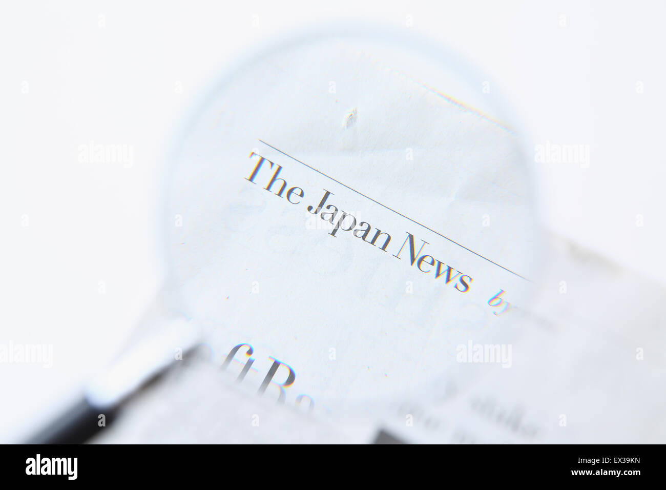 Newspaper and magnifying glass Stock Photo - Alamy