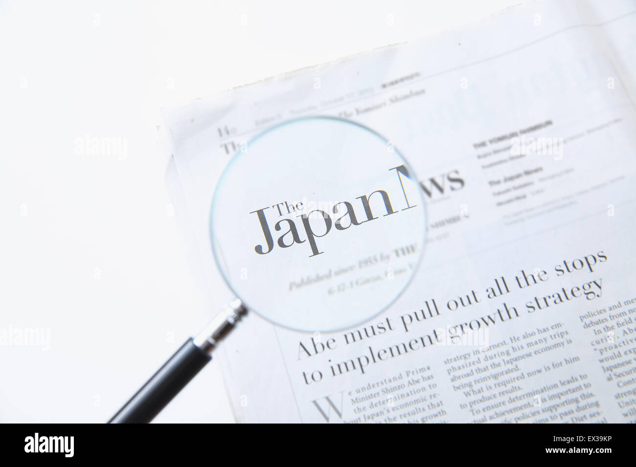 Newspaper and magnifying glass Stock Photo - Alamy