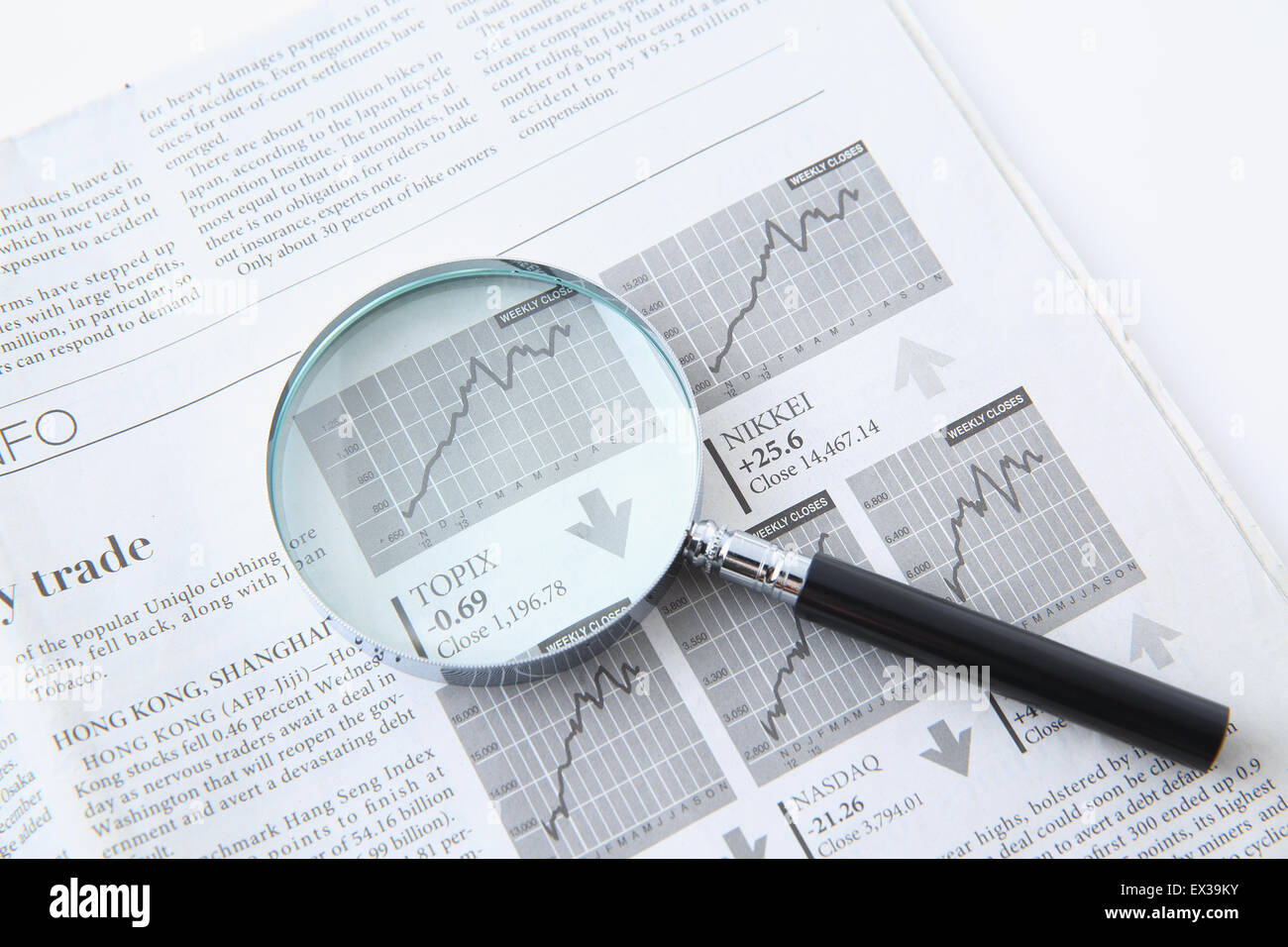 Newspaper and magnifying glass Stock Photo - Alamy