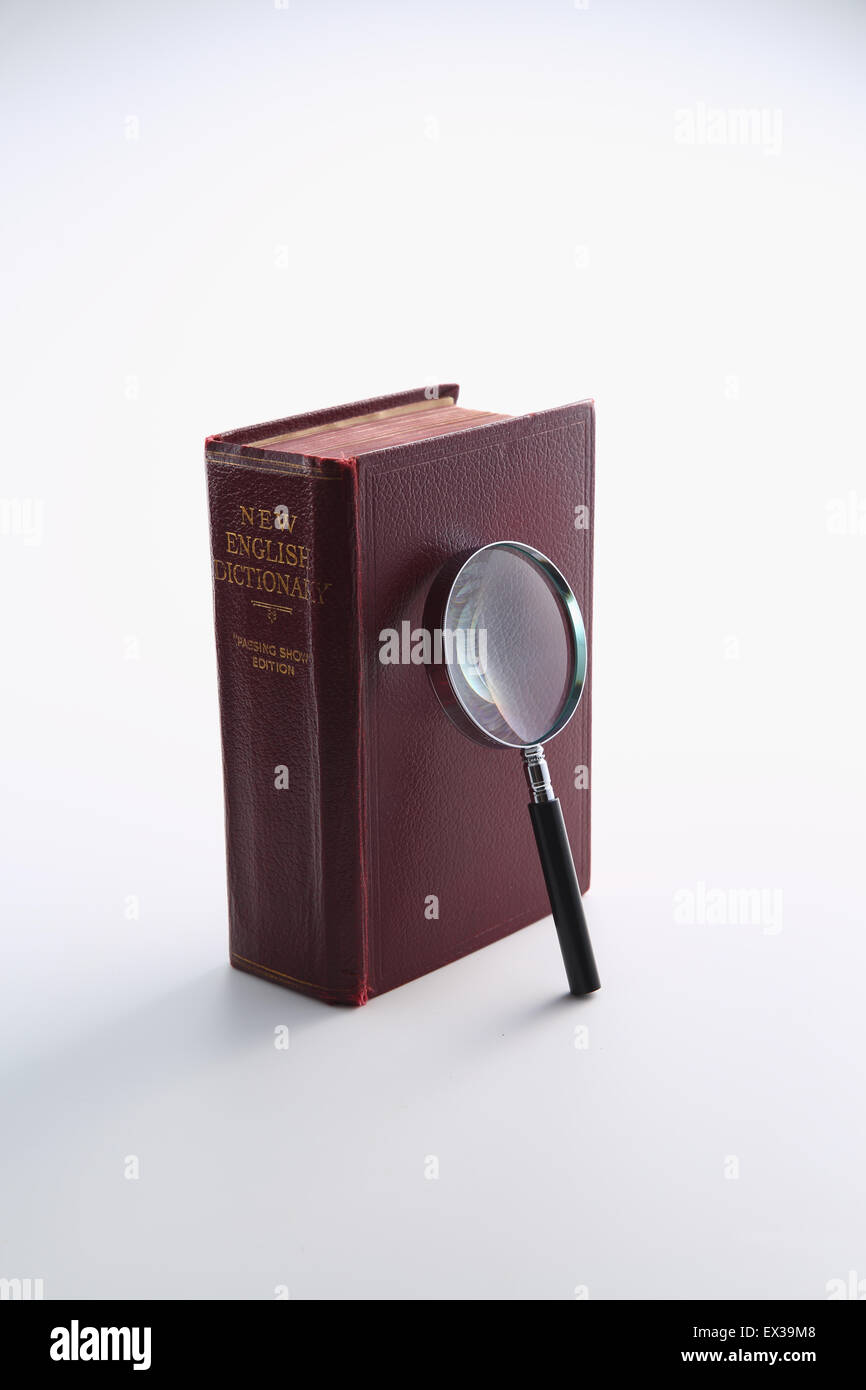 Dictionary and magnifying glass Stock Photo - Alamy